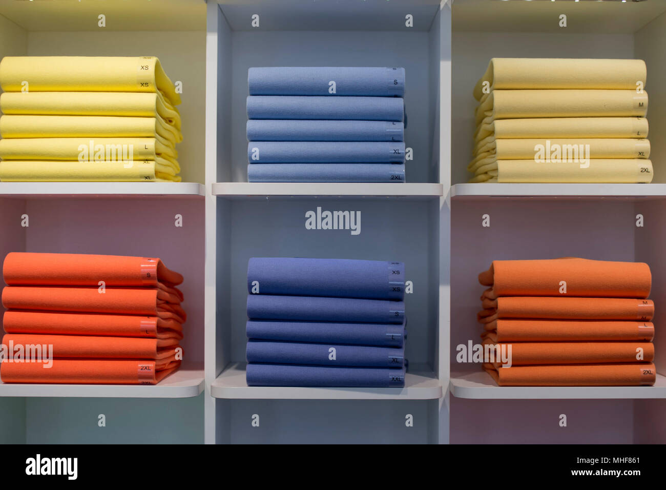 different colors polo shirt on display stand Stock Photo - Alamy