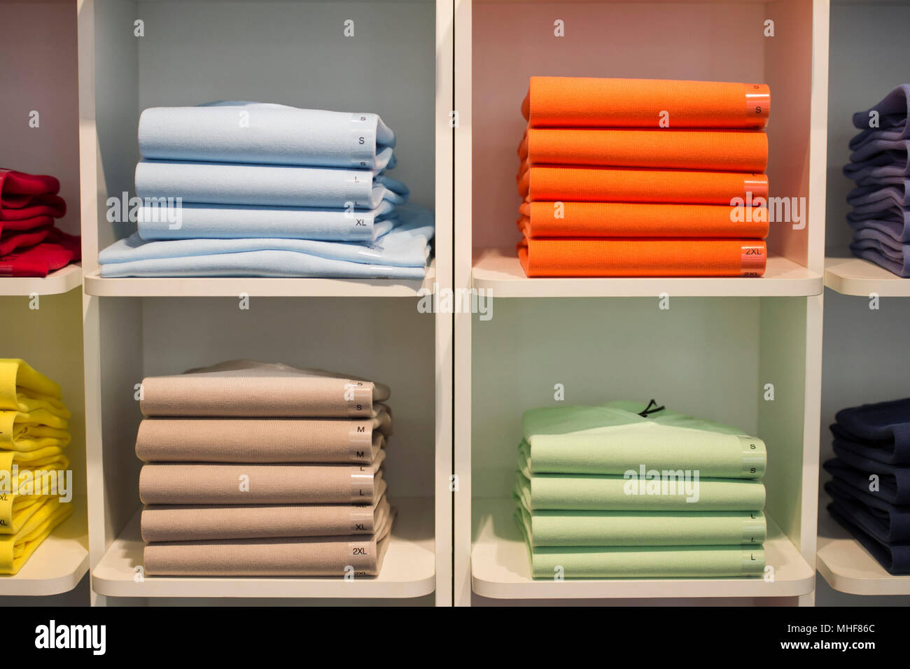 different colors polo shirt on display stand Stock Photo - Alamy