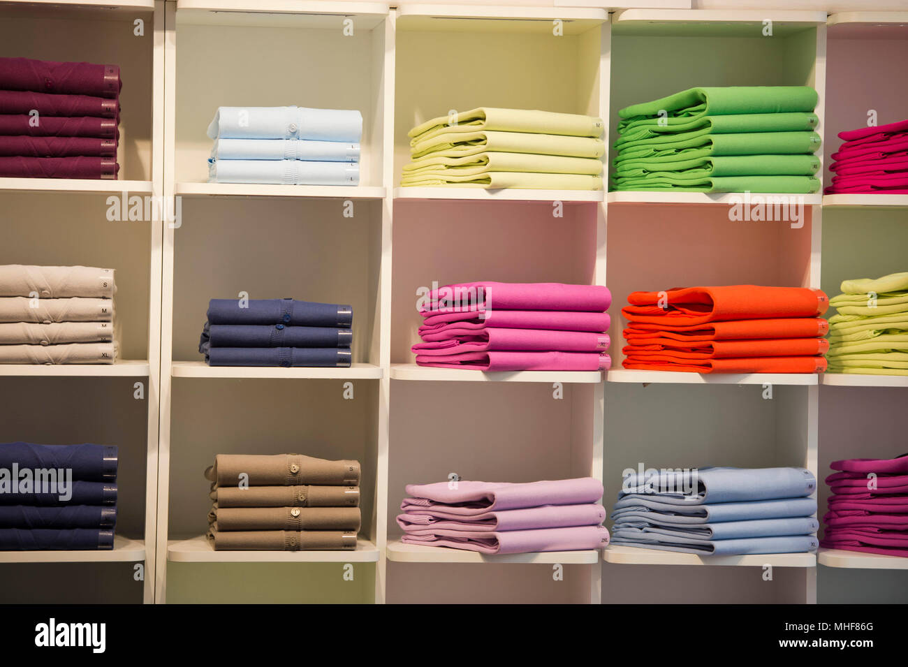 different colors polo shirt on display stand Stock Photo - Alamy