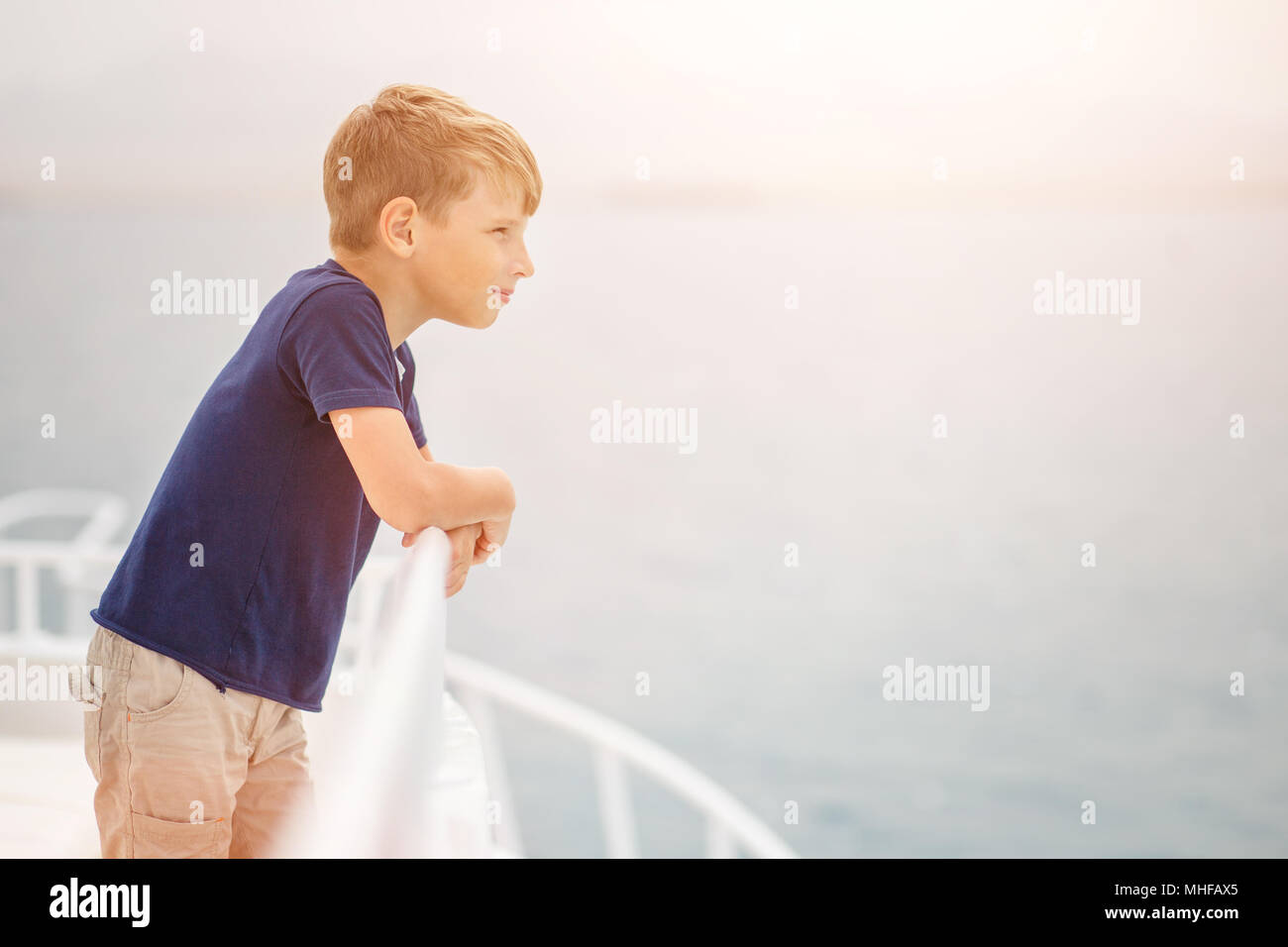 Small boy enjoying summer vacation on sea. Happy boy on yacht cruise ...
