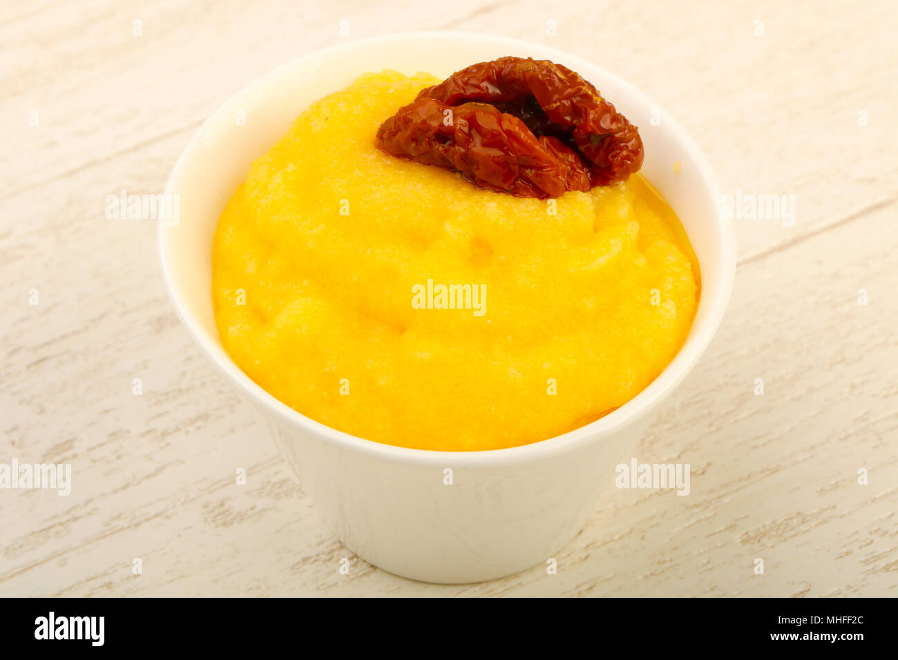 Polenta with dry tomato Stock Photo - Alamy