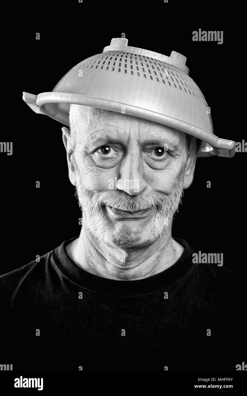 Dramatic black and white Portrait of a mad man with a plastic strainer ...