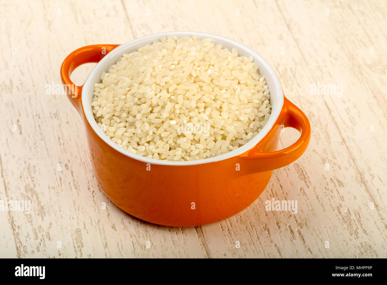 Raw rice heap in the bowl - ready for cooking Stock Photo - Alamy
