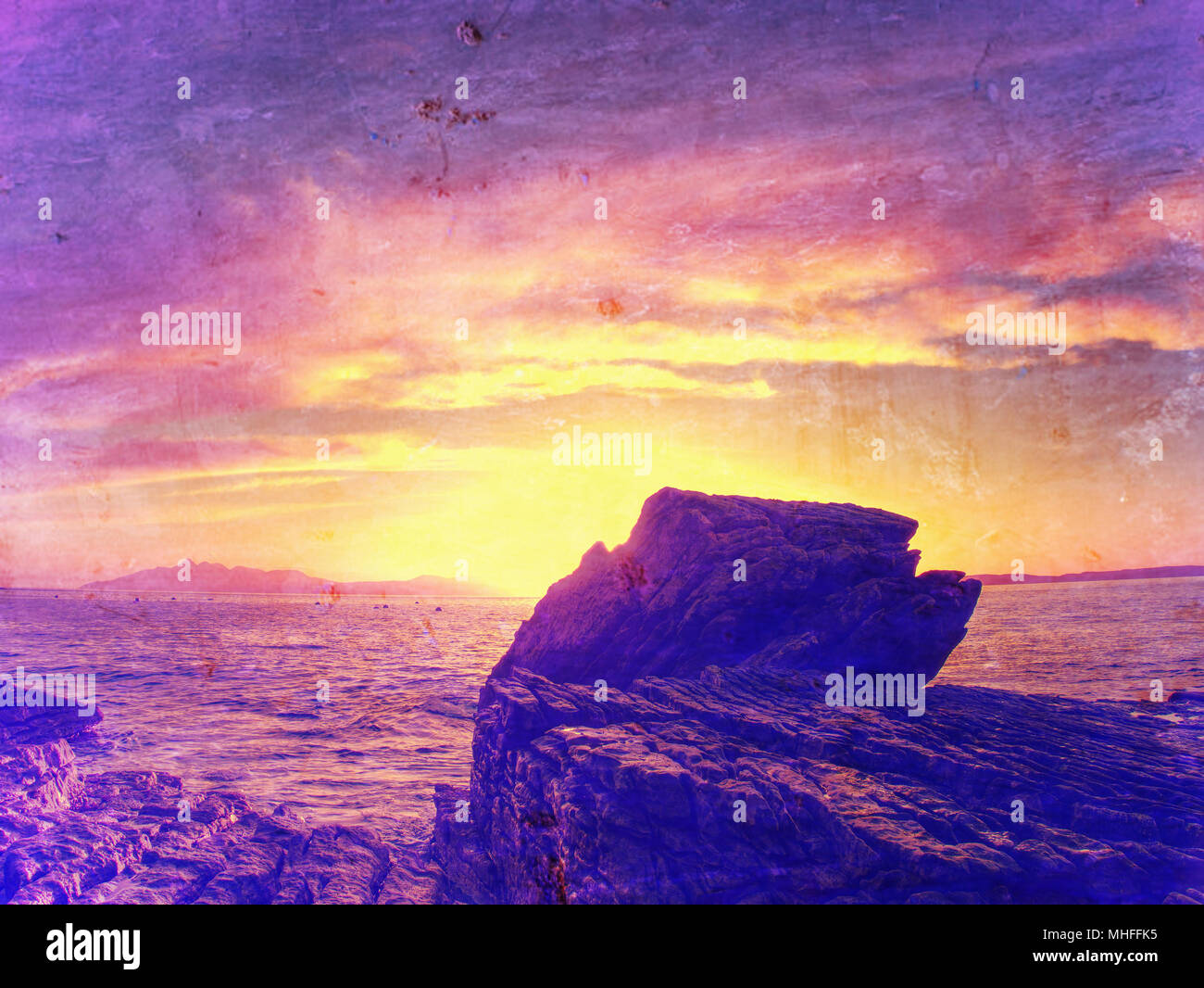 Abstract effect. Rocks and boulders on shore. Poor warm sunset light ...