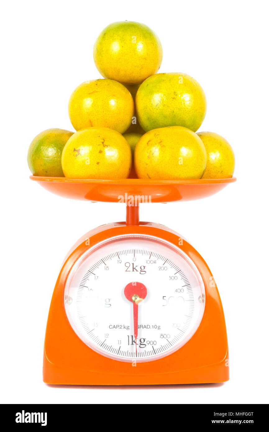 many fresh orange lying on weight scale Stock Photo - Alamy