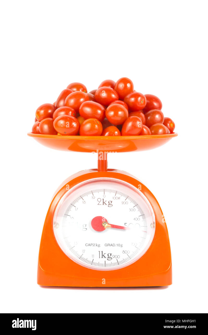 many fresh small tomato lying on weight scale Stock Photo - Alamy