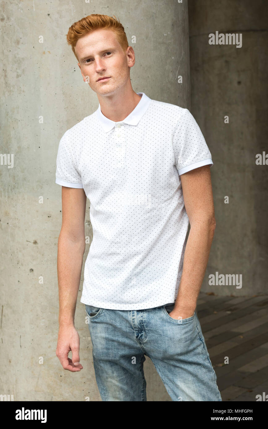 Portrait of a young male model with red hair. Outdoor portrait of a ...