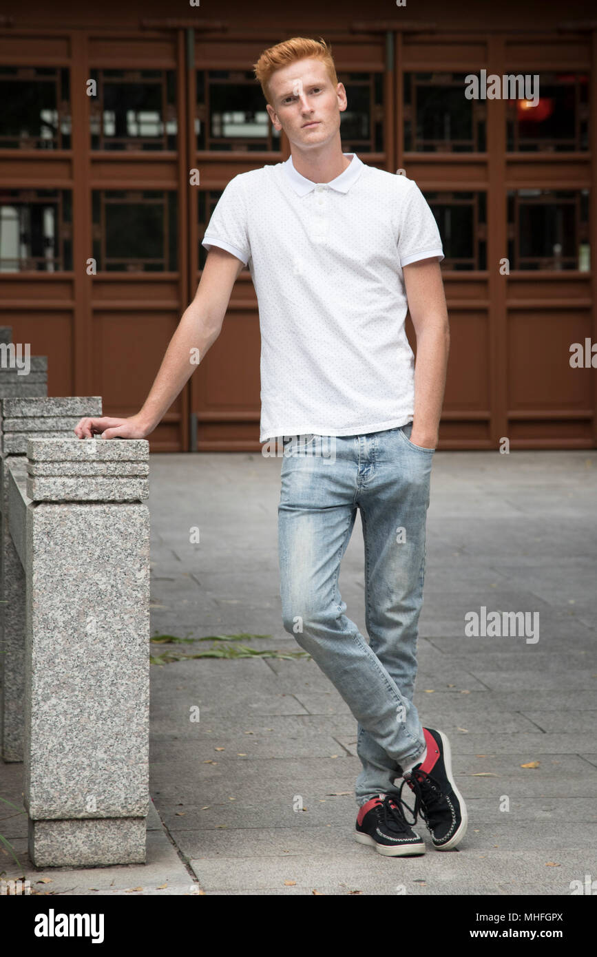 Portrait of a young male model with red hair. Outdoor portrait of a ...