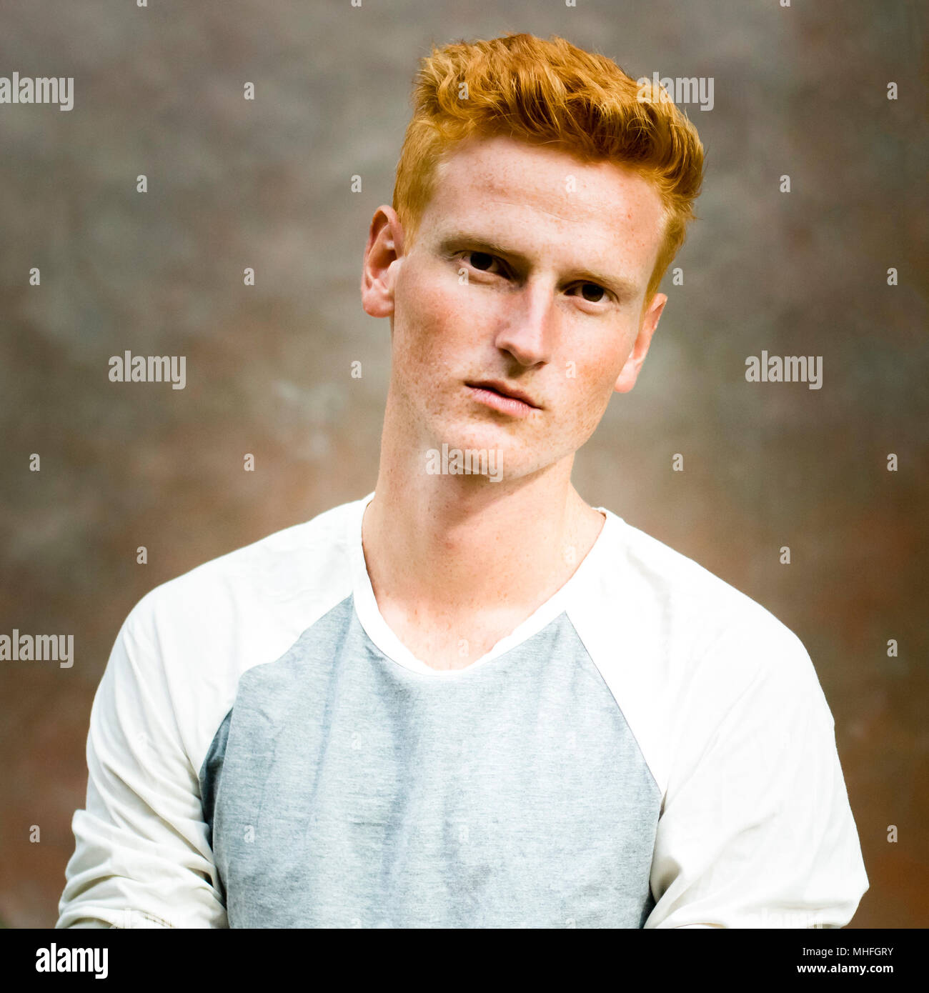 Portrait of a young male model with red hair. Outdoor portrait of a ...