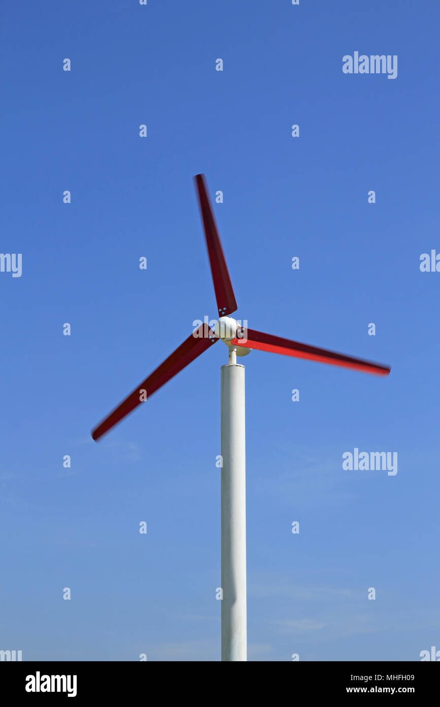 wind wheel in front of a blue, overcast sky Stock Photo - Alamy