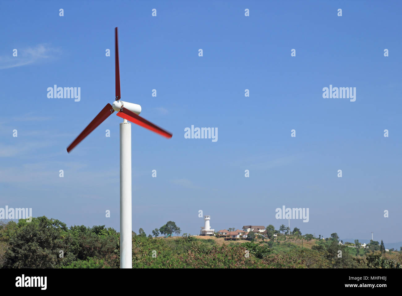 wind wheel in front of a blue, at mountain Stock Photo - Alamy