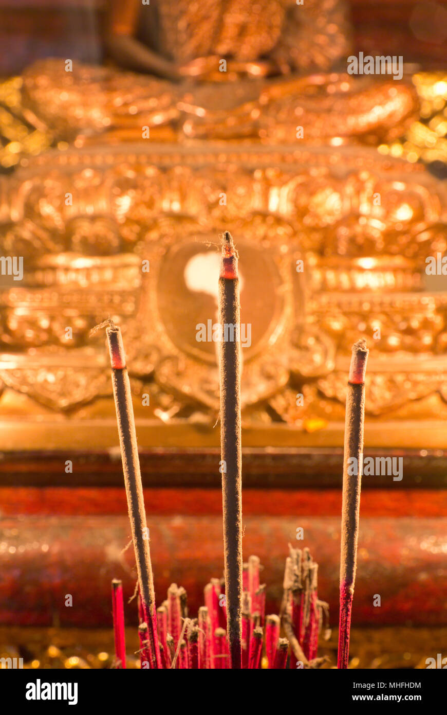 Buddha image behind burning joss stick Stock Photo - Alamy
