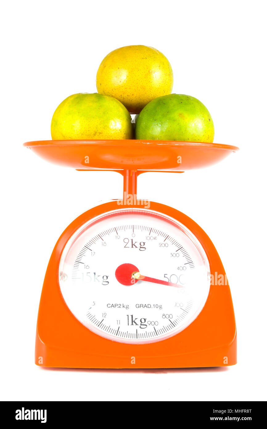 many orange lying on weight scale Stock Photo - Alamy