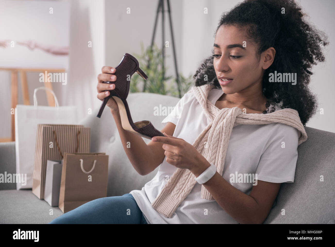 Beautiful young woman looking at the shoes Stock Photo - Alamy