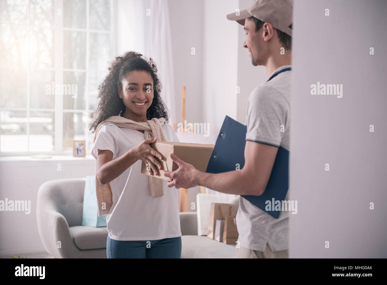 Positive happy woman taking the box Stock Photo - Alamy