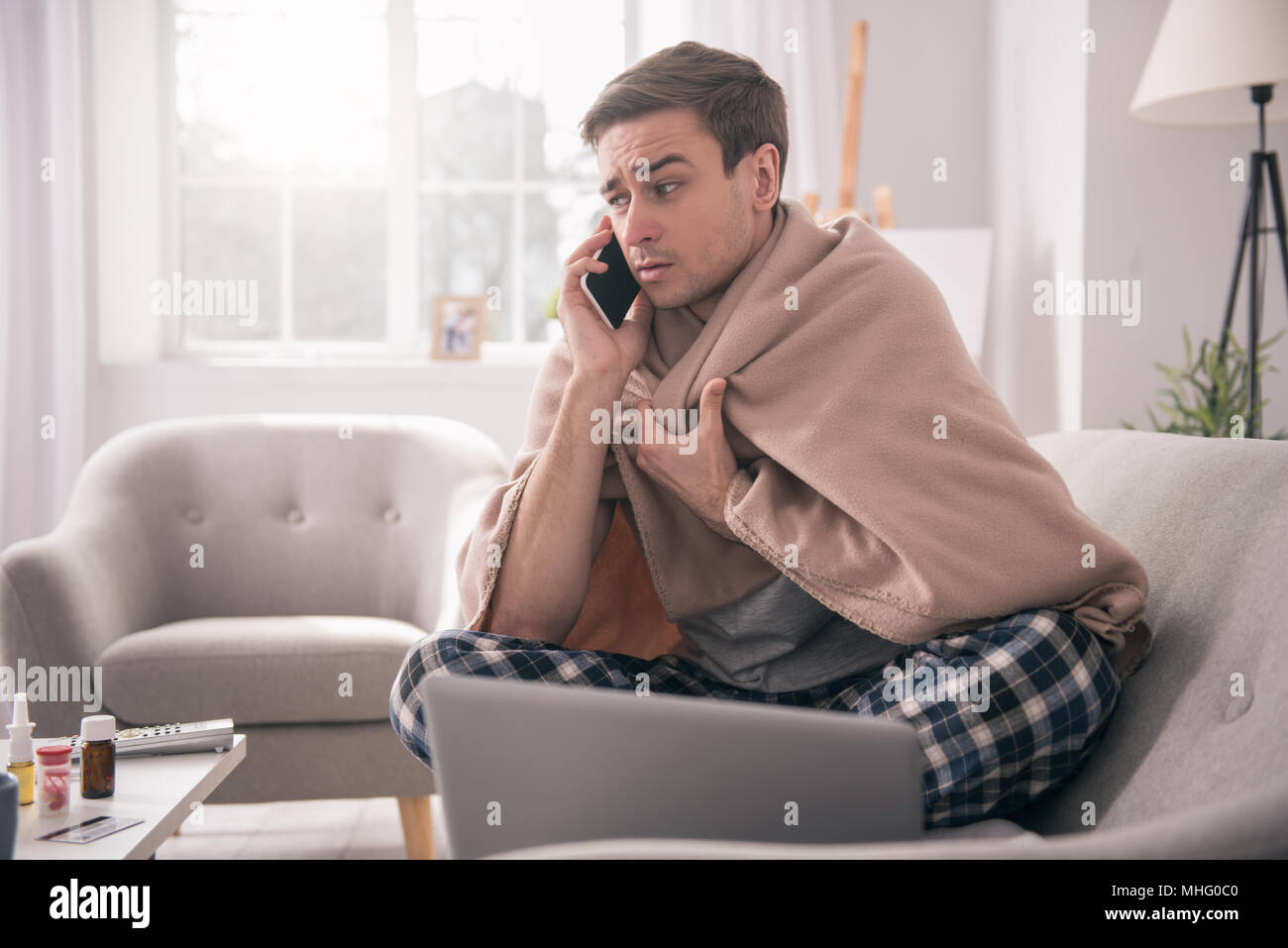 Sad young man talking to his employer Stock Photo - Alamy