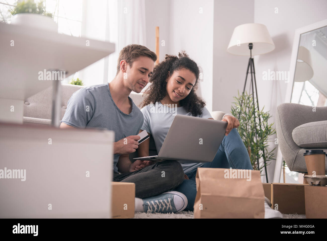 Nice happy couple browsing the Internet Stock Photo - Alamy