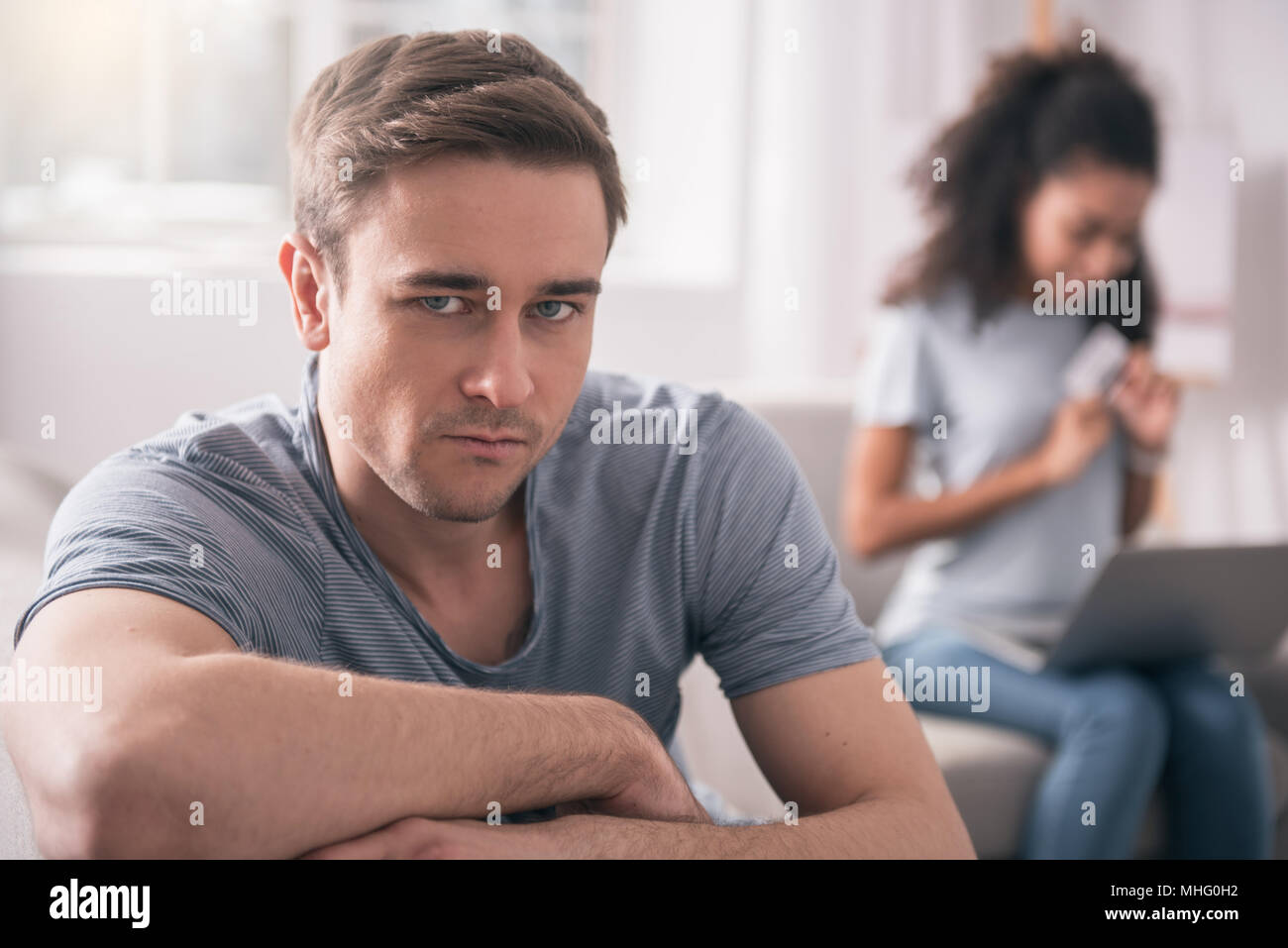Sad cheerless man looking at you Stock Photo - Alamy