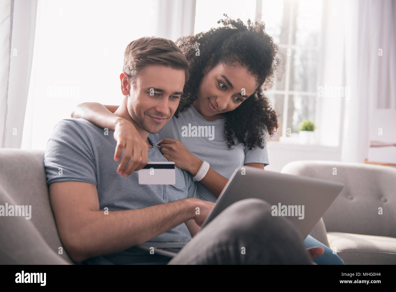 Happy nice couple looking at the laptop screen Stock Photo - Alamy
