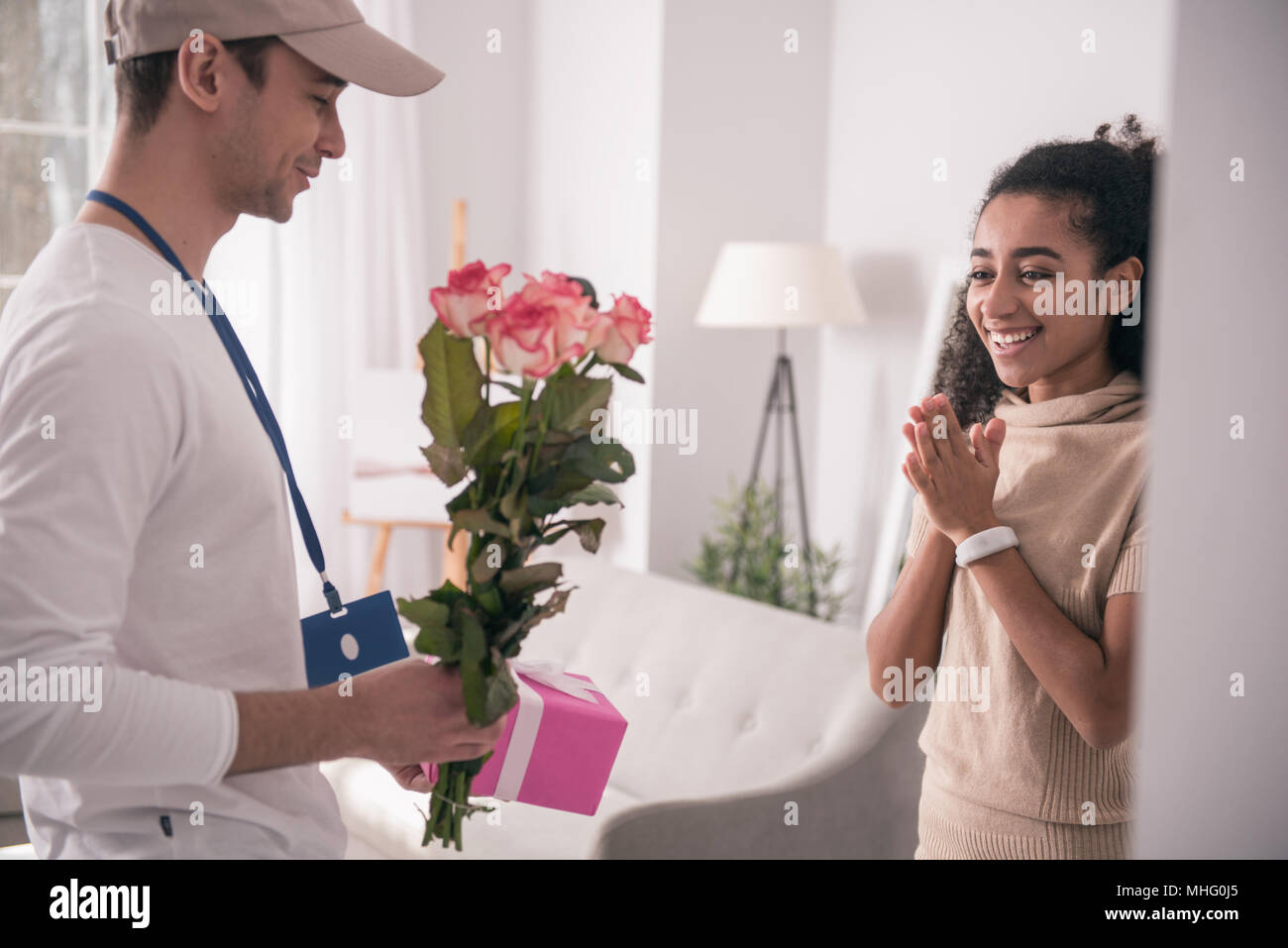 Joyful nice woman receiving a present Stock Photo - Alamy