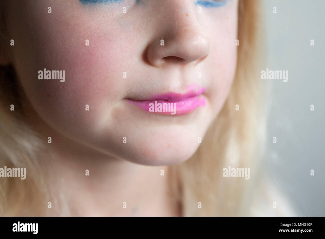 Blonde child girl kid, playing with makeup, eyeshadow, lipstick, pink ...