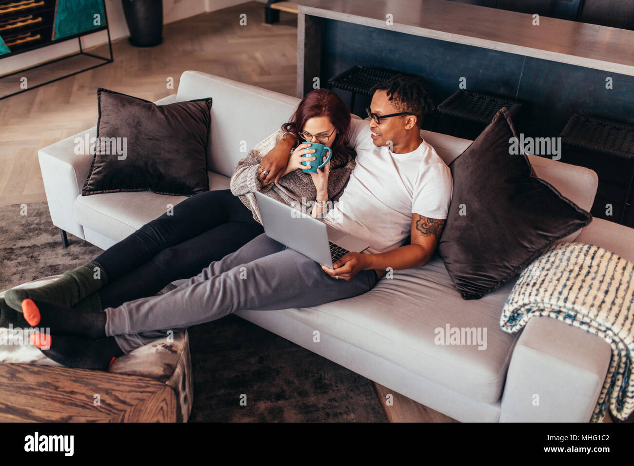 Relaxed couple sitting couch hi-res stock photography and images - Alamy