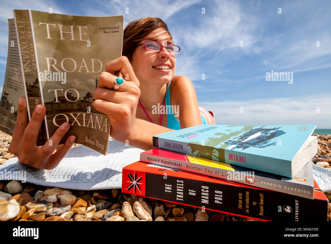 Reading books on the beach Stock Photo - Alamy
