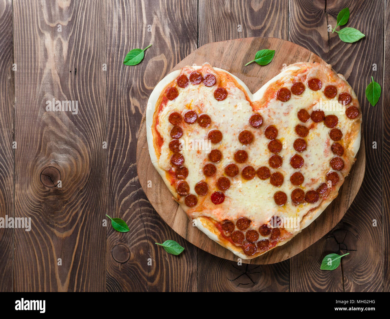 Pepperoni pizza in heart shape and dad word Stock Photo - Alamy