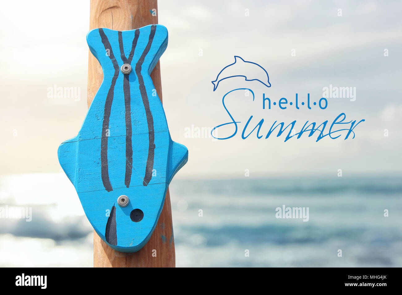 vacation and summer image with wooden decorative fish in front of the ...