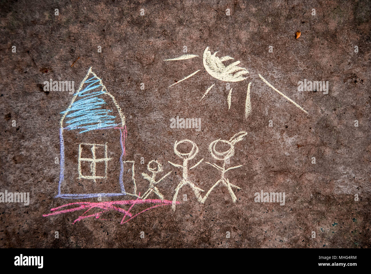 A child draws a family with chalk Stock Photo - Alamy