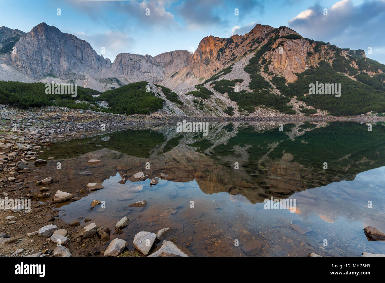 Amazing Sunrise with Colored in red rock of Sinanitsa peak and the lake ...