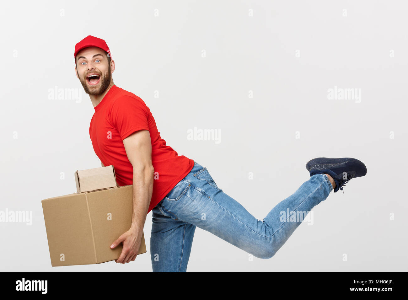 Delivery Concept - Handsome caucasian delivery man rush running for ...