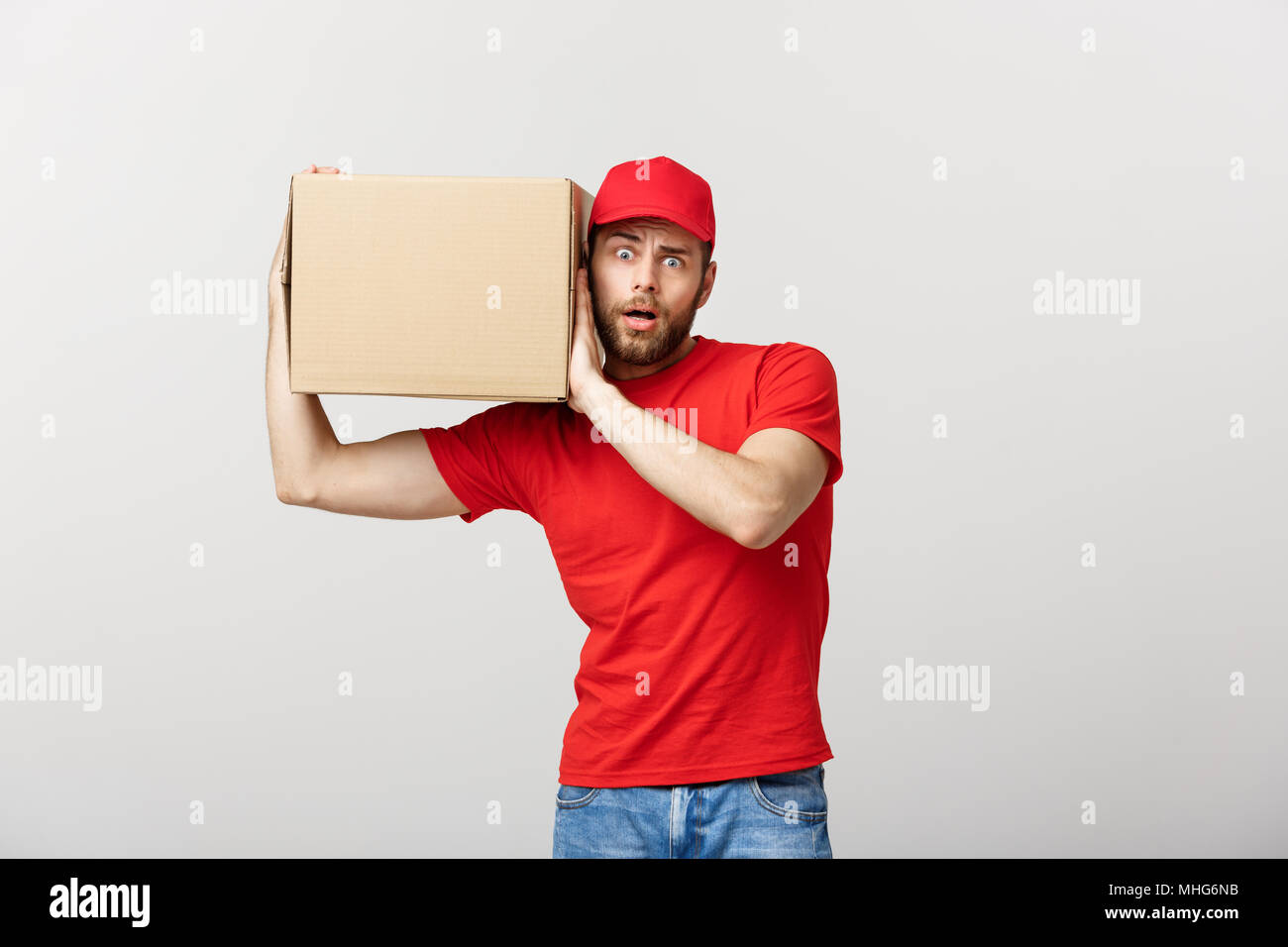 Delivery Concept - Portrait of Curious caucasian handsome delivery man ...