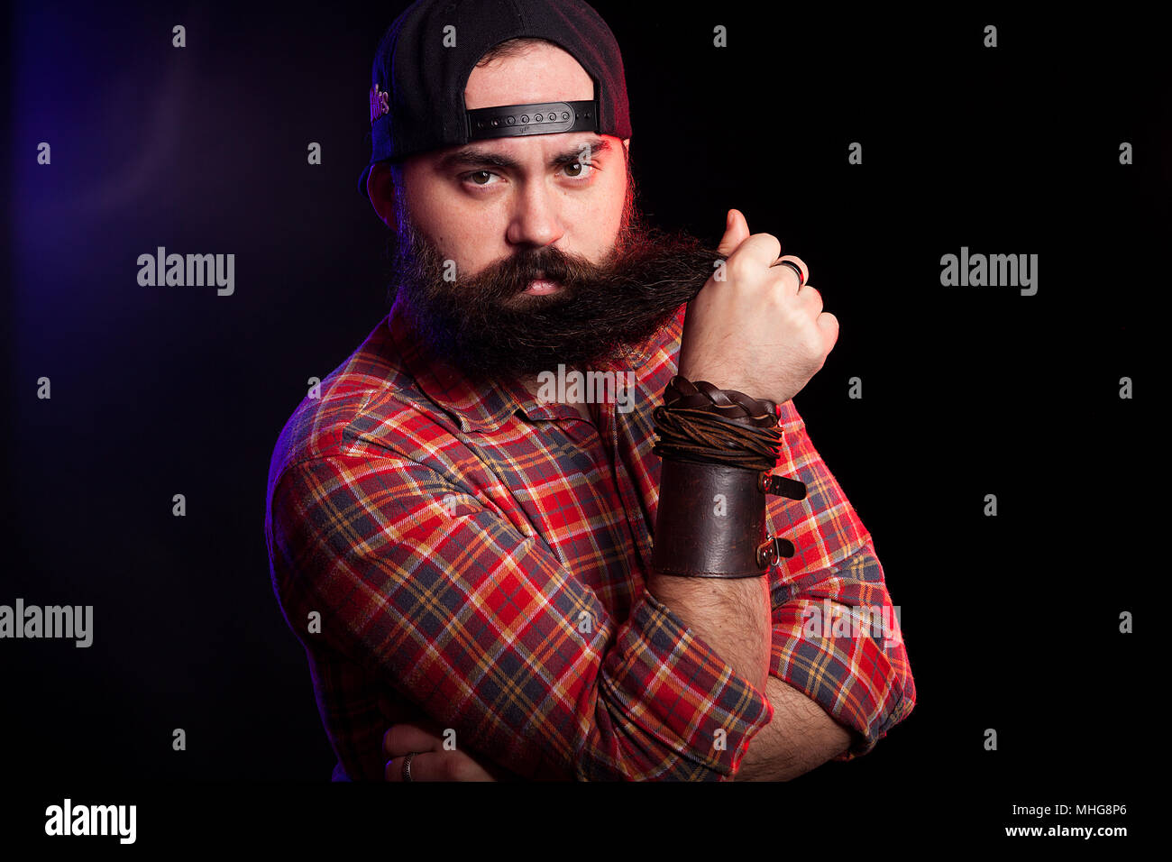 Angry bearded hipster man holding his beard in hands Stock Photo - Alamy