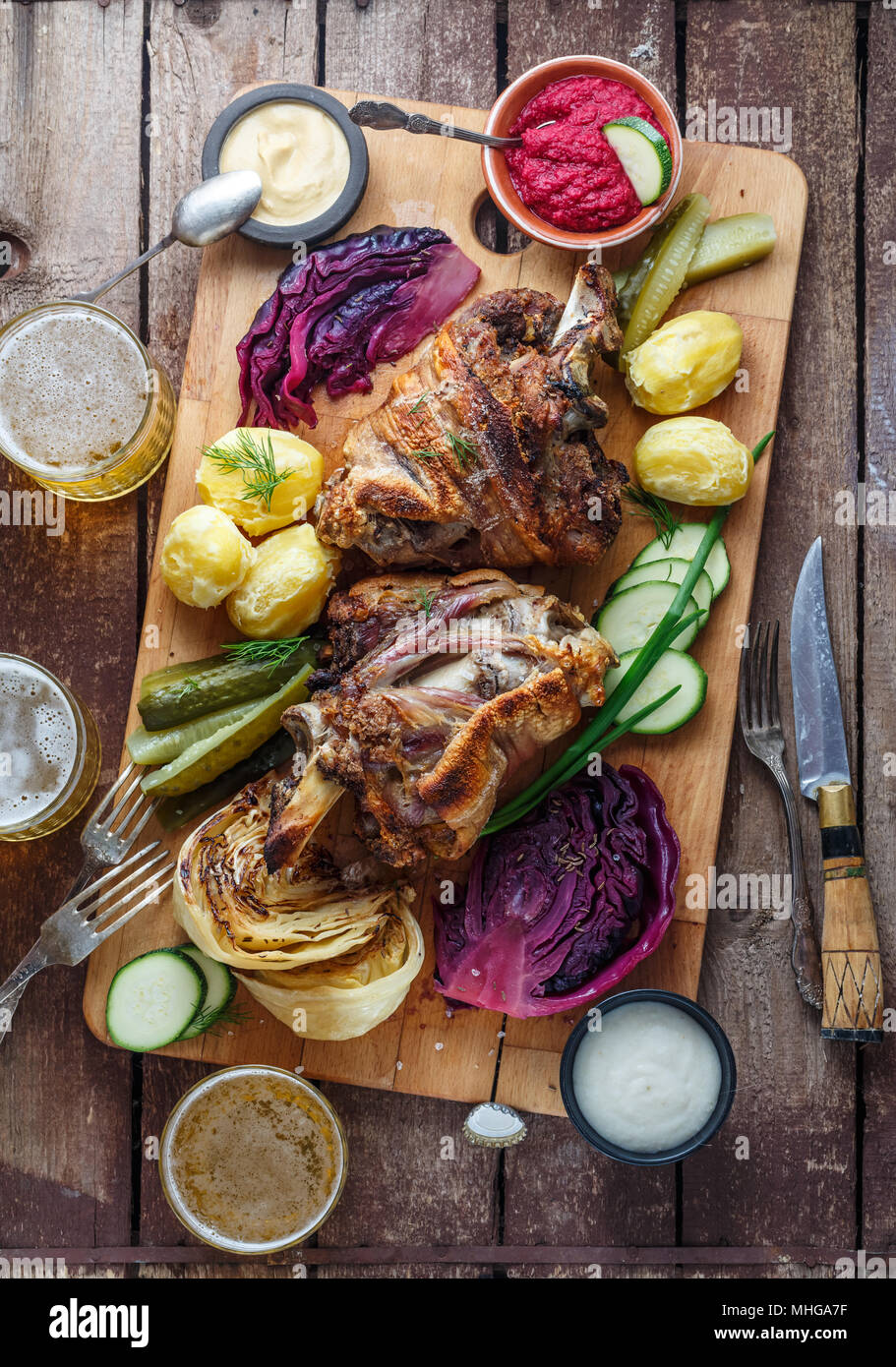 Roasted pork knuckle eisbein with braised boiled cabbage, potato ...