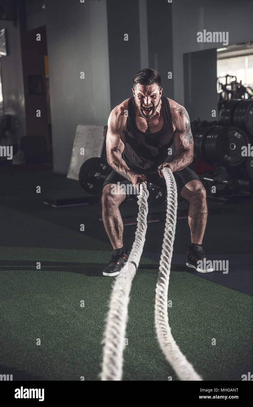 Men with rope in functional training fitness Stock Photo - Alamy