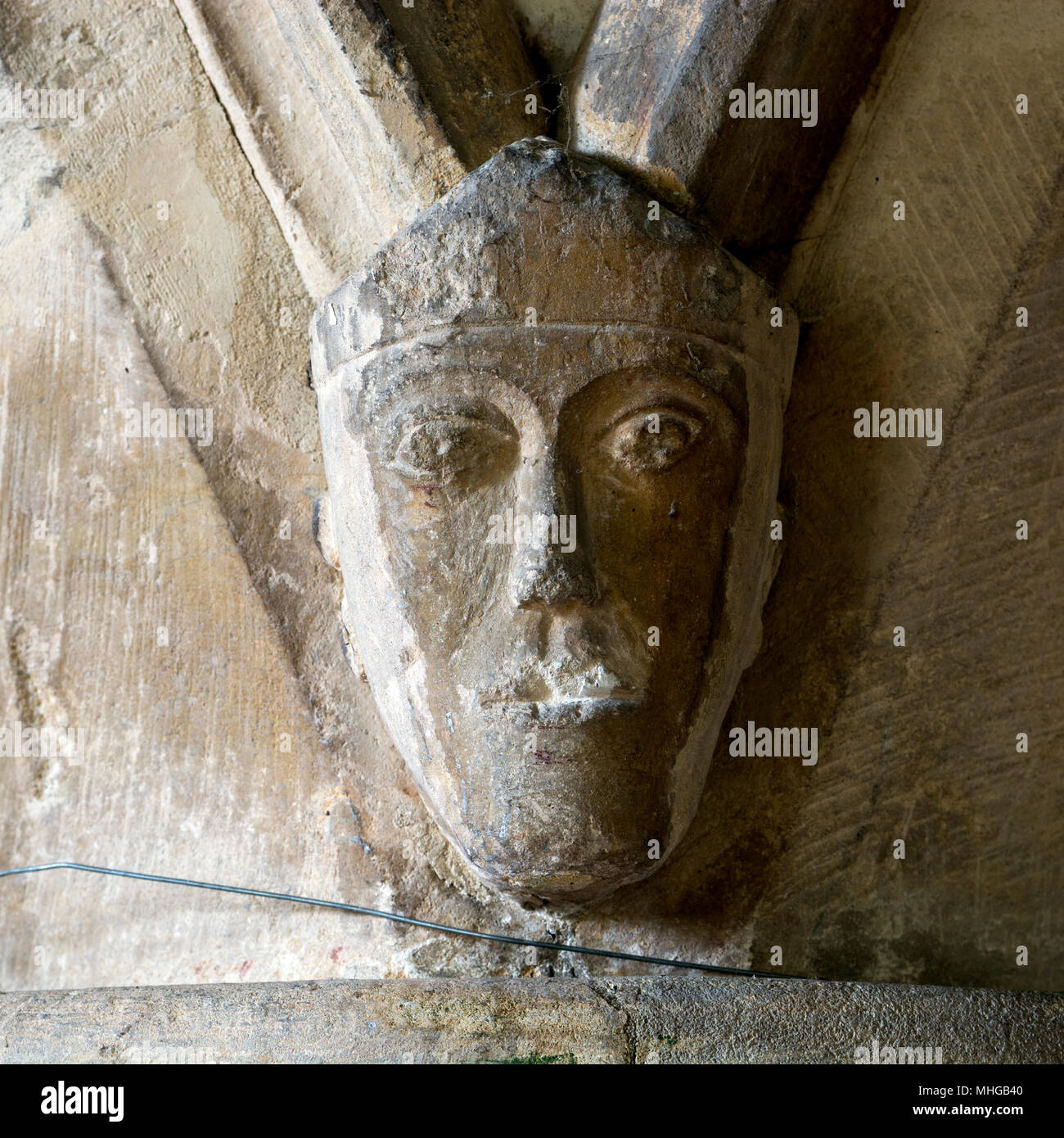 A carved head in St. Matthew`s Church, Coates, Gloucestershire, England ...