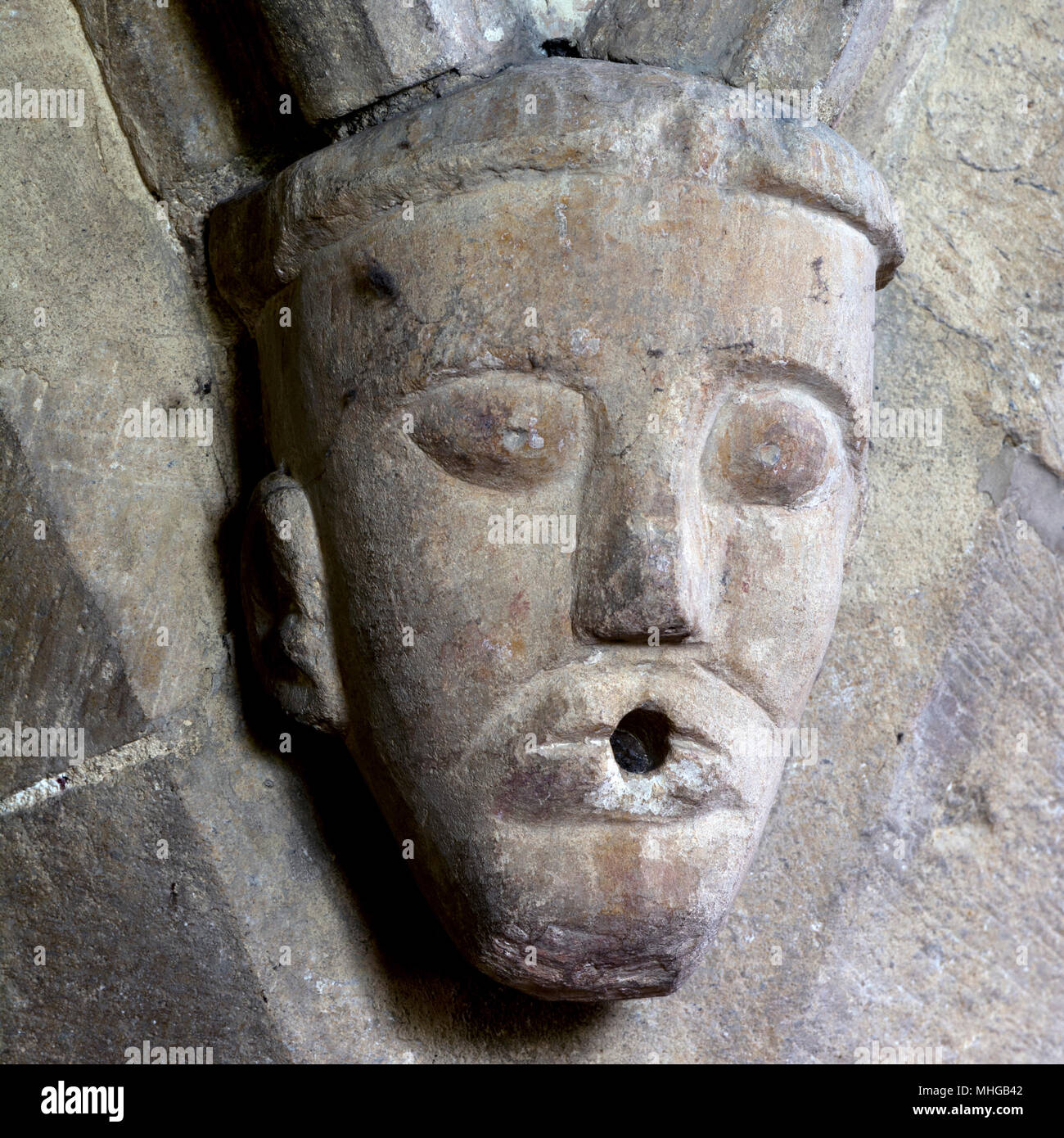A carved head in St. Matthew`s Church, Coates, Gloucestershire, England ...