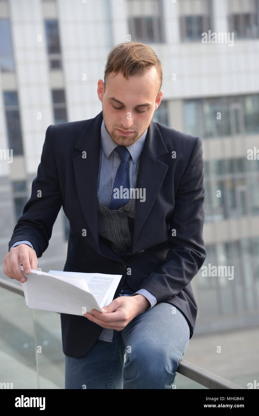 Young businessman holding paper documents hi-res stock photography and ...