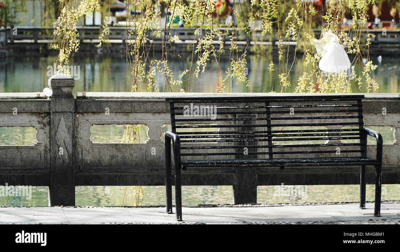 Old bench with river and tree at the background Stock Photo - Alamy