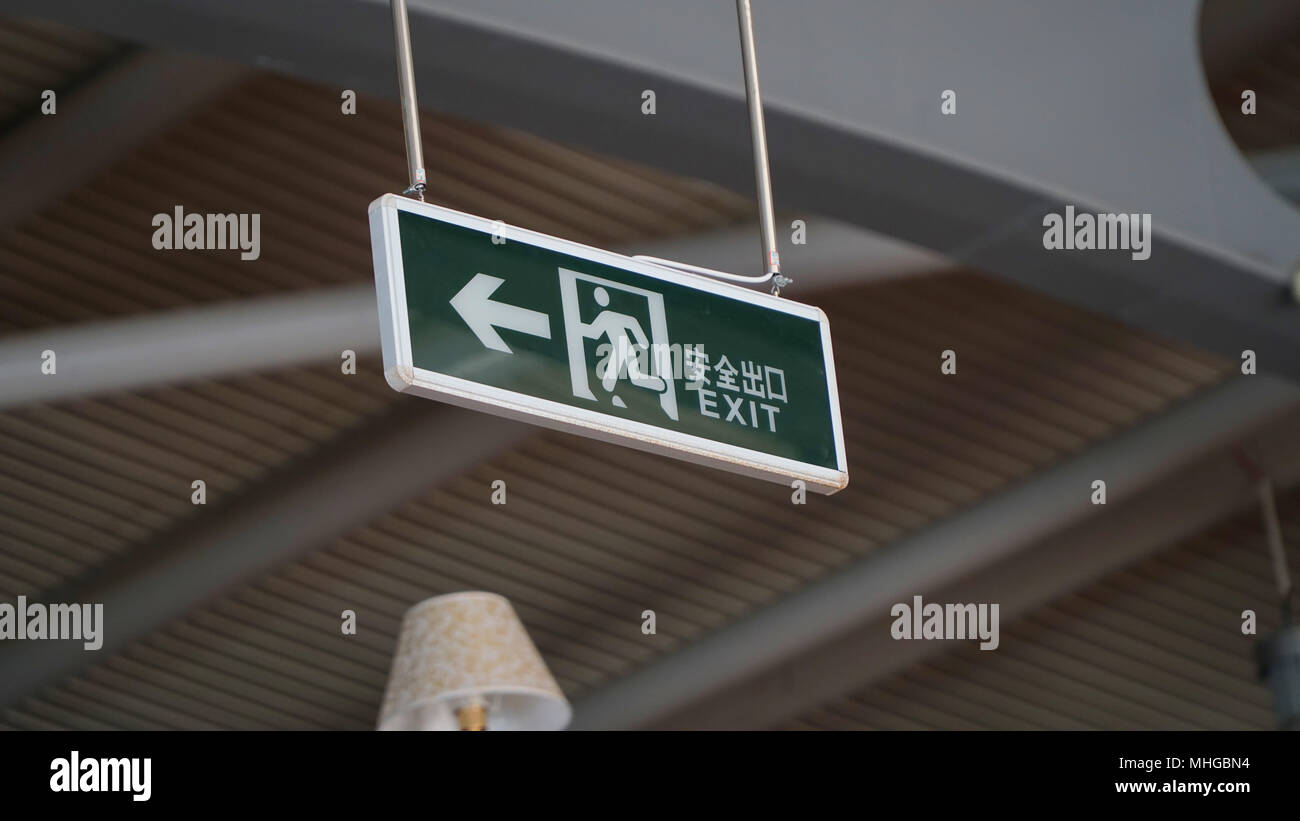 Exit Sign with roof background inside the building Stock Photo - Alamy