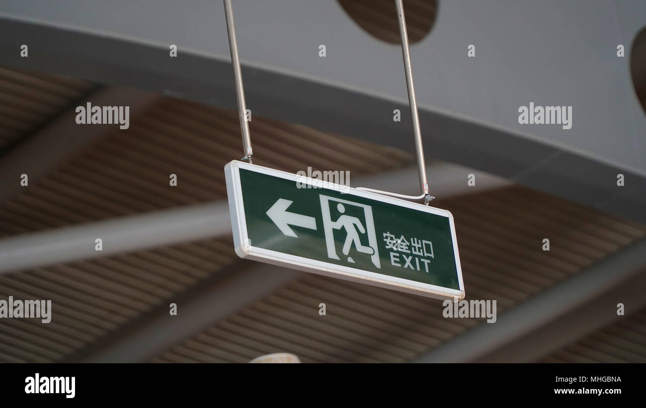 Exit Sign with roof background inside the building Stock Photo - Alamy