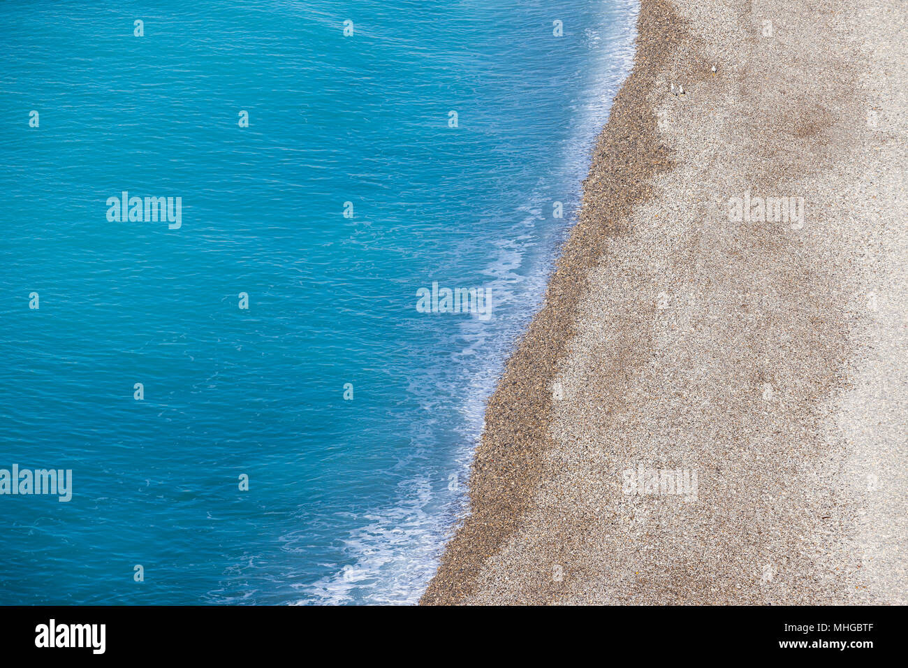Pebble beach and sea aerial view background on a sunny summer day in ...