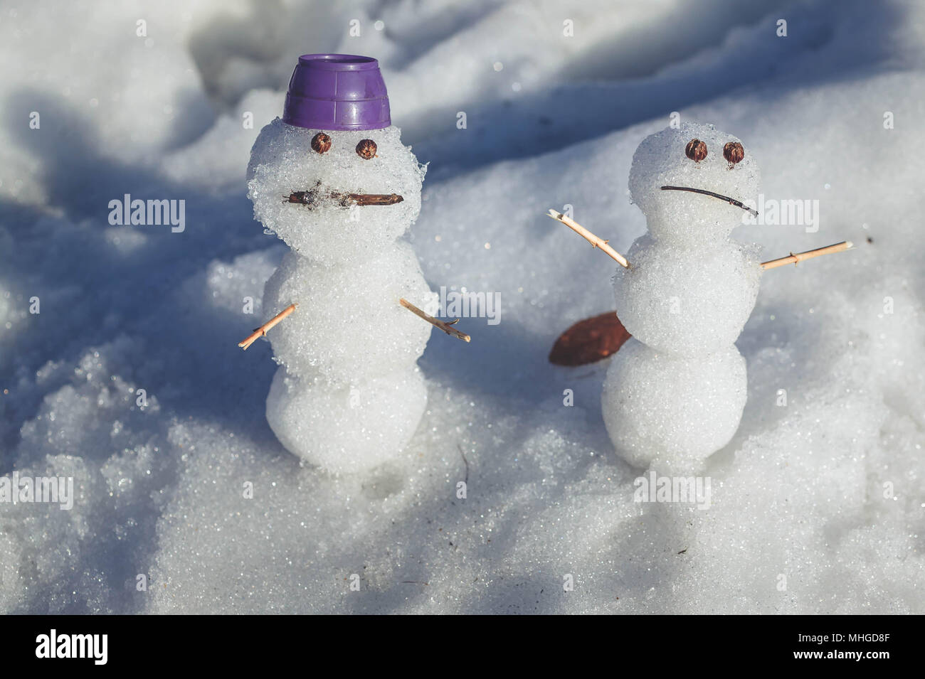 Sad snowmen. Spring came and the snow melts Stock Photo - Alamy