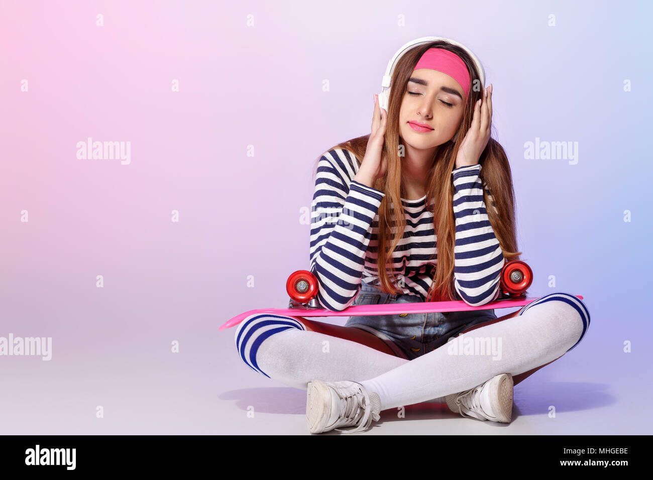 beautiful woman with skate in studio Stock Photo - Alamy