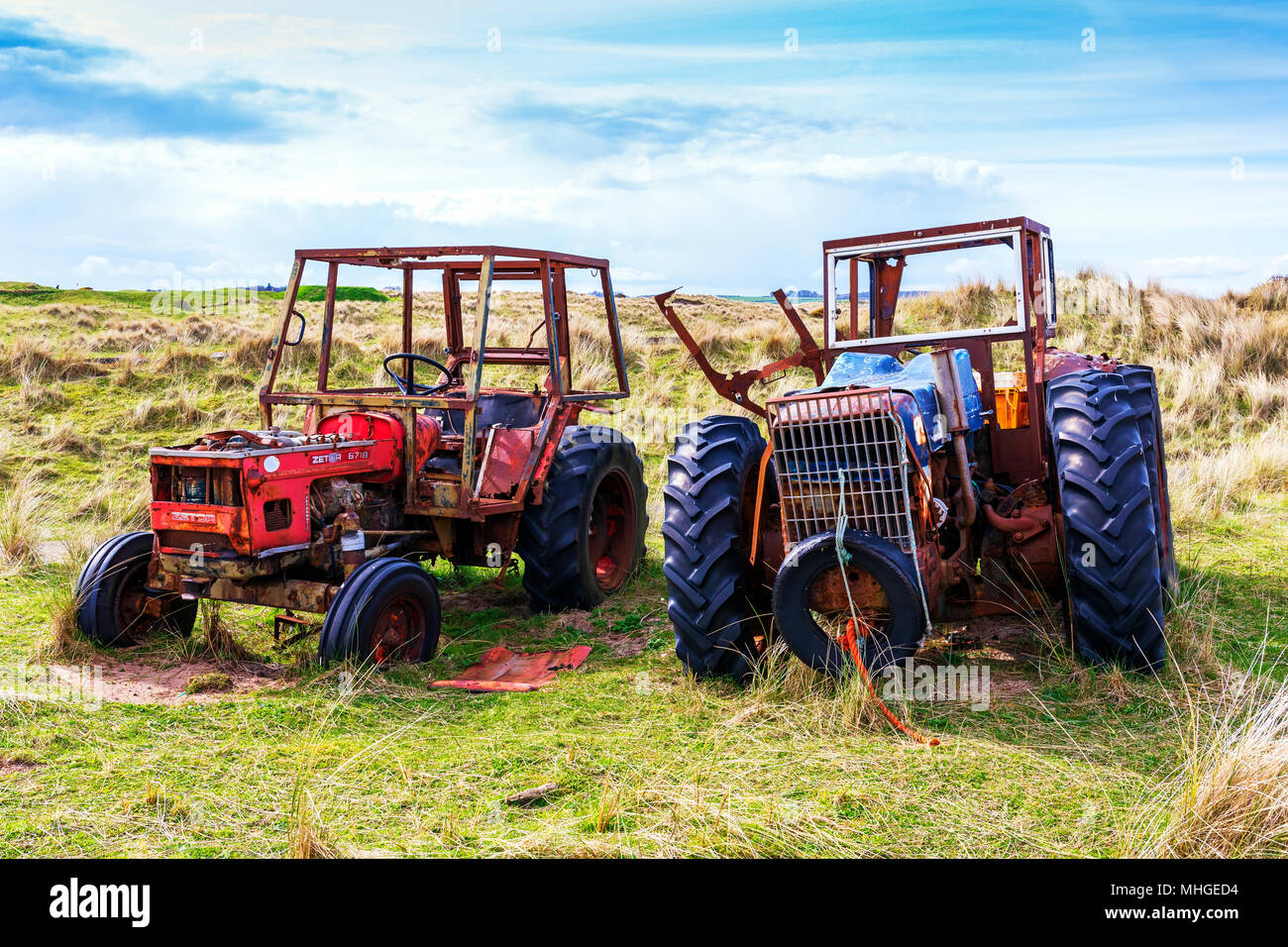 Two old and abandoned farm tractors in a field near Goswick ...