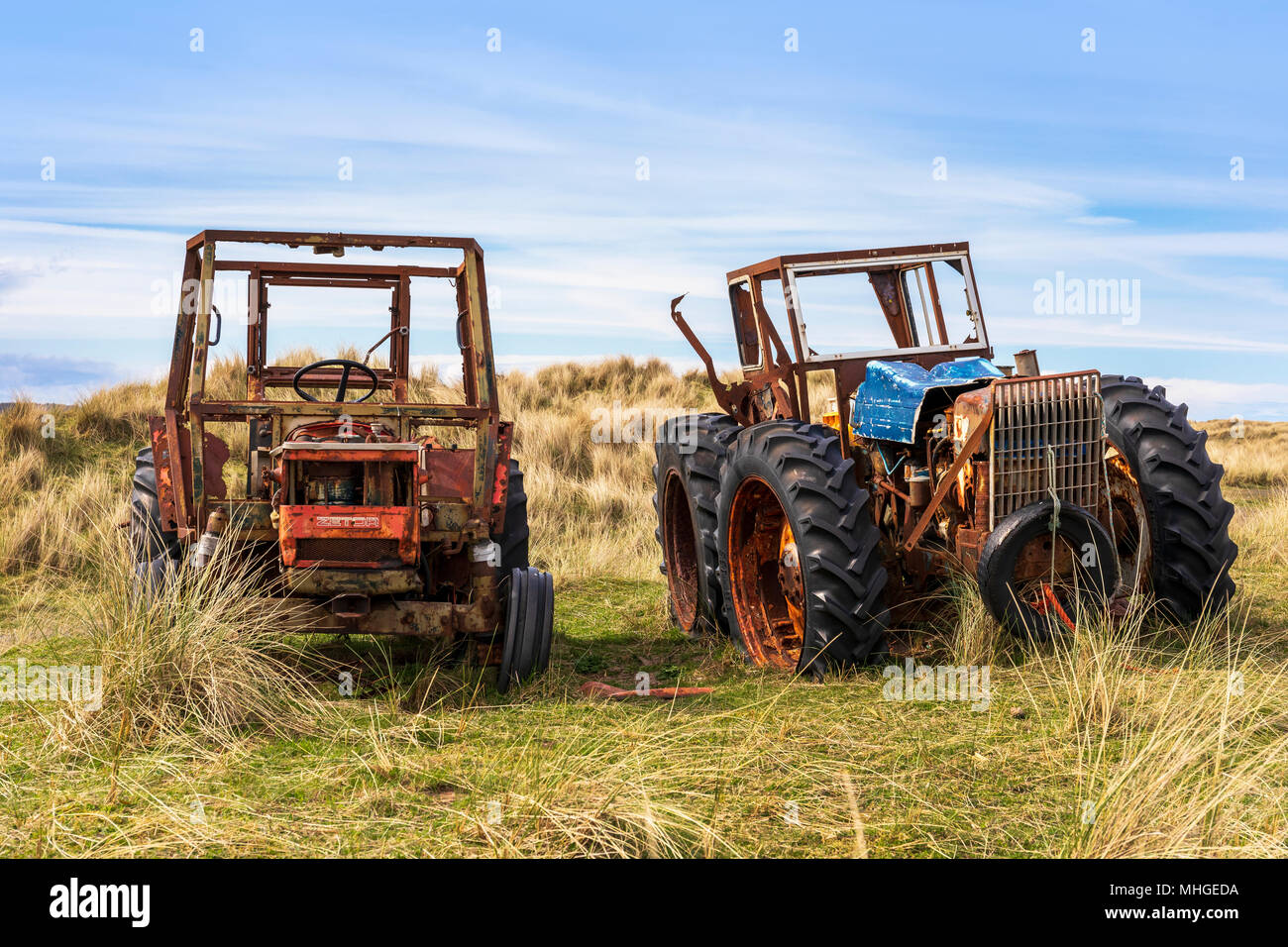 Two abandoned and rusting farm tractors in a field near Goswick ...