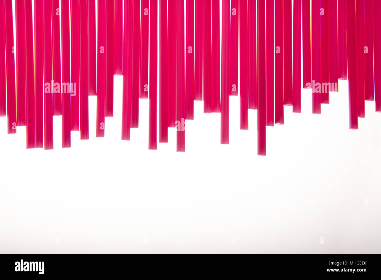 Red straws in a decorative background pattern two-thirds into the frame ...