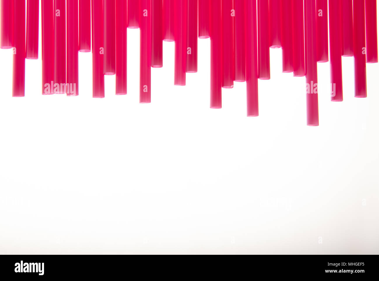 Red straws in a decorative background pattern one-thirds into the frame ...