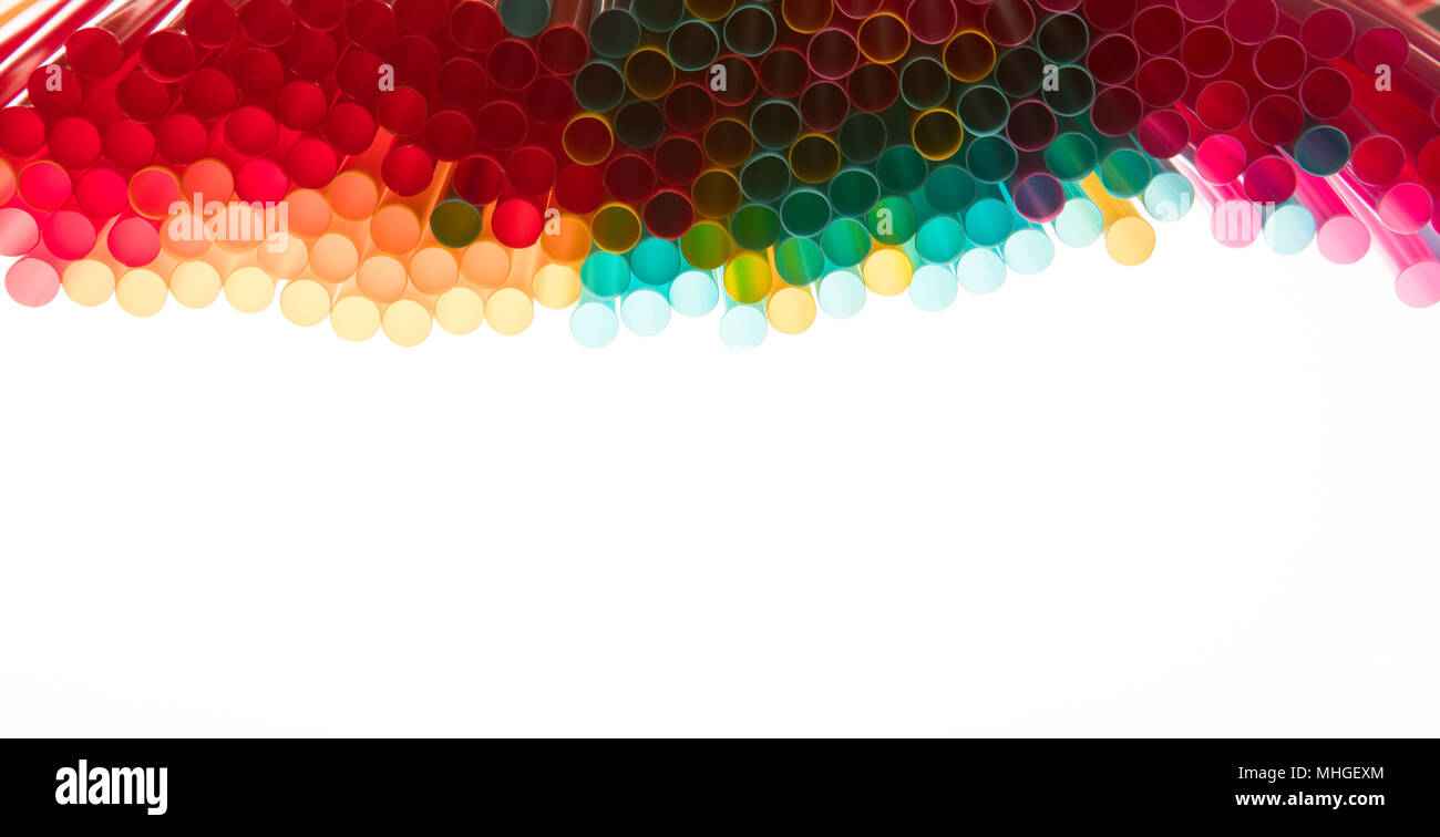 Vivid color straws into the frame in an uneven line over a decorative ...